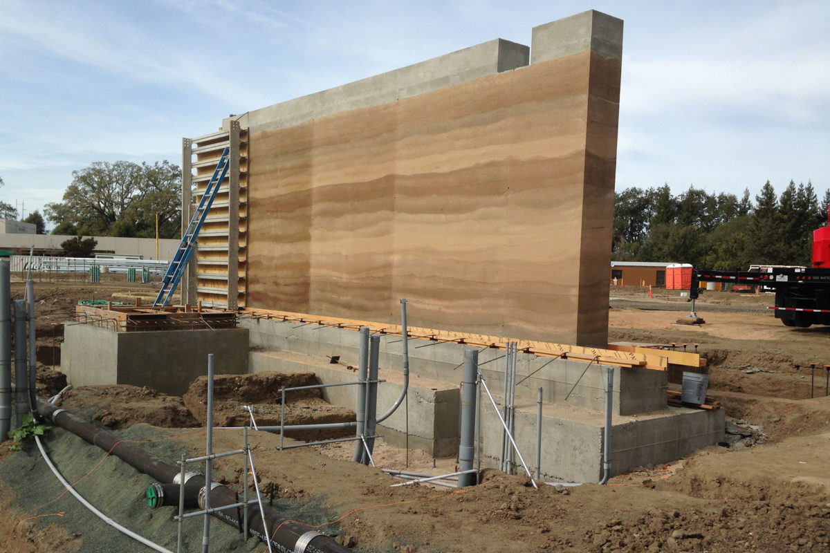 Rammed Earth Wall Rises at TLCD Project - TLCD Architecture